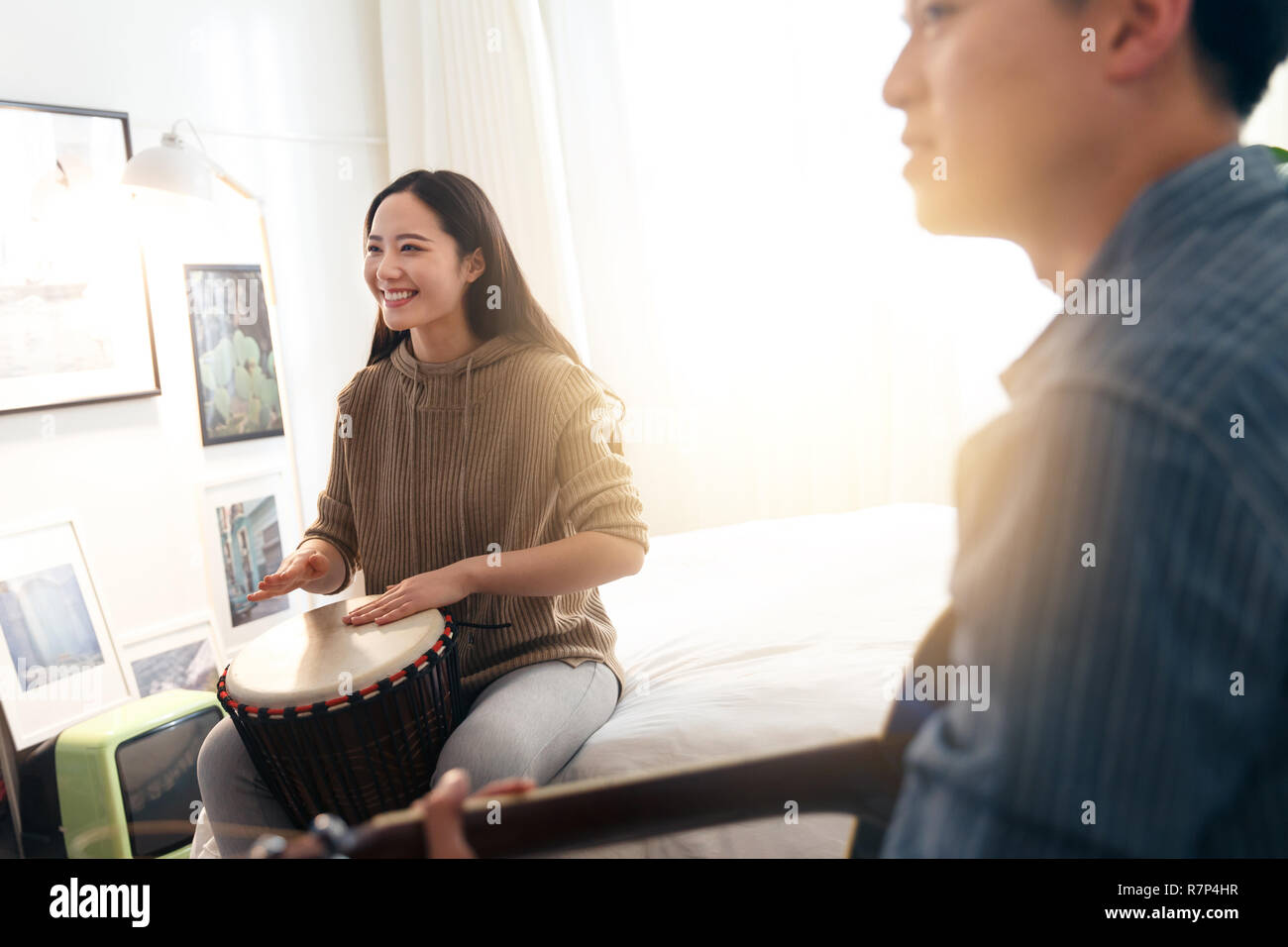 Happy couples playing Musical Instruments at home Stock Photo - Alamy