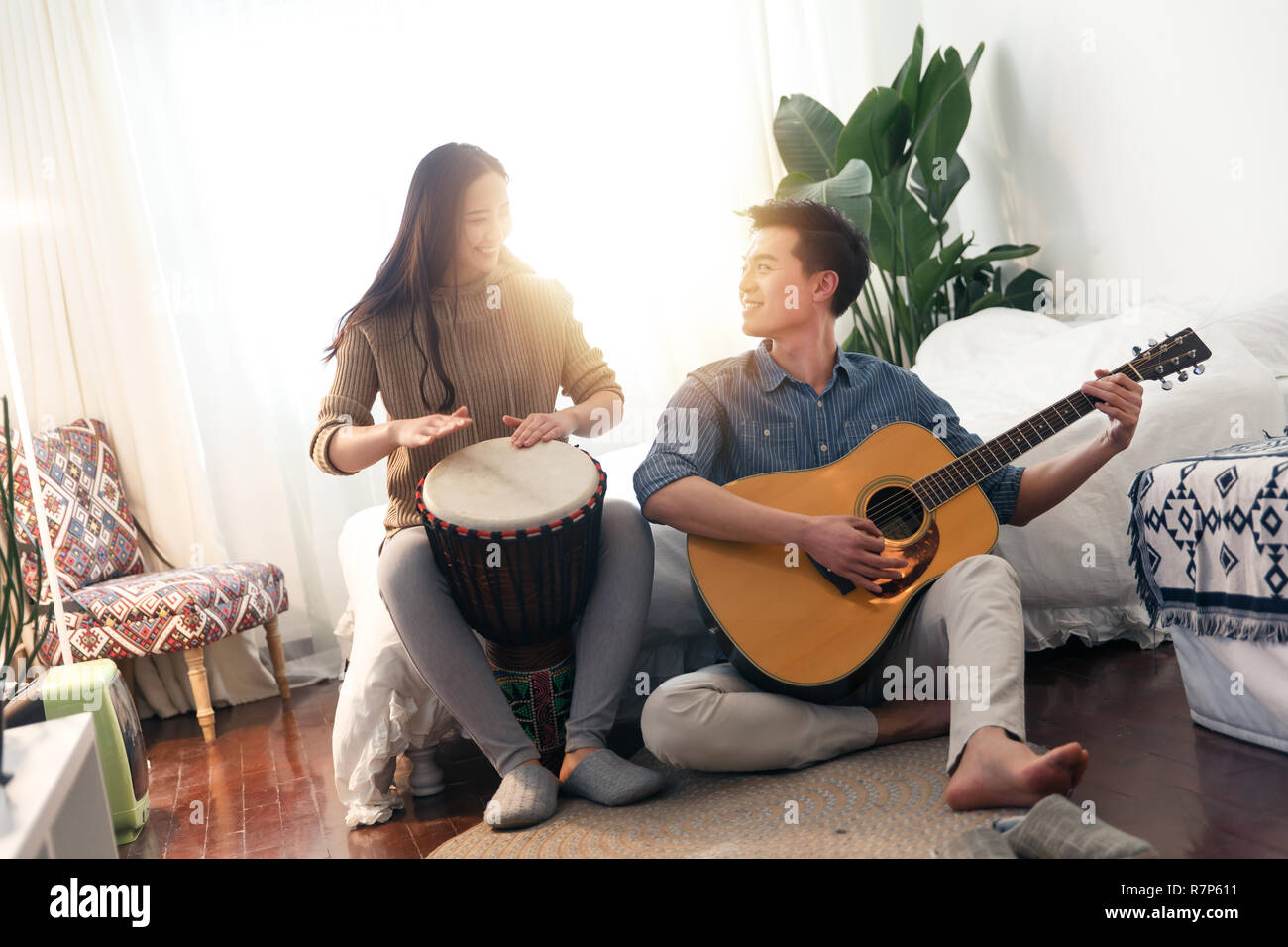 Happy couples playing Musical Instruments at home Stock Photo - Alamy
