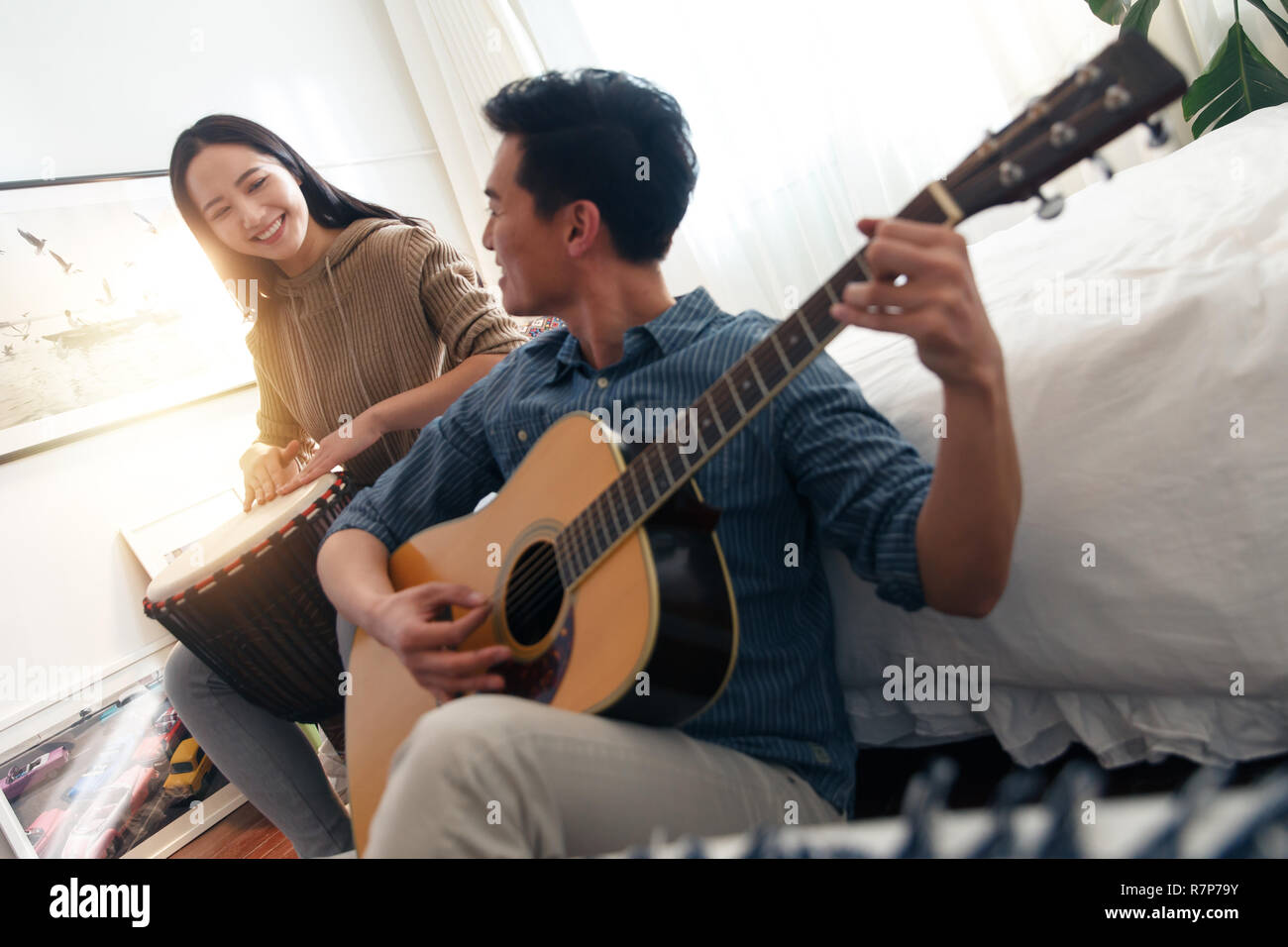 Happy couples playing Musical Instruments at home Stock Photo - Alamy
