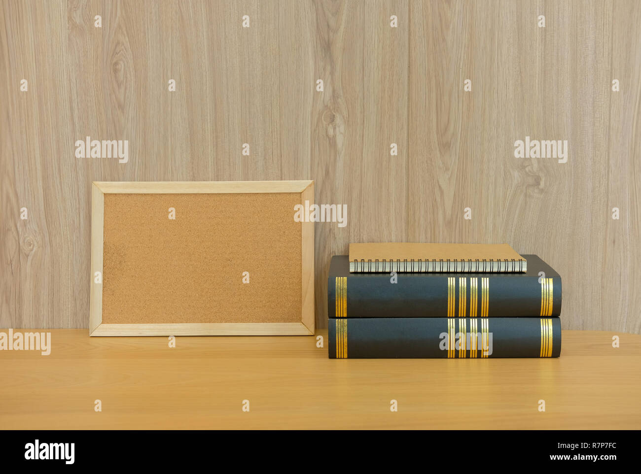 blank cork board notebook & book on wooden desk at workplace. education ...
