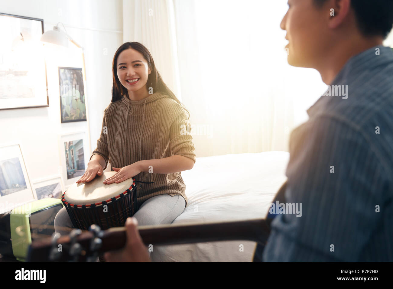 Happy couples playing Musical Instruments at home Stock Photo - Alamy