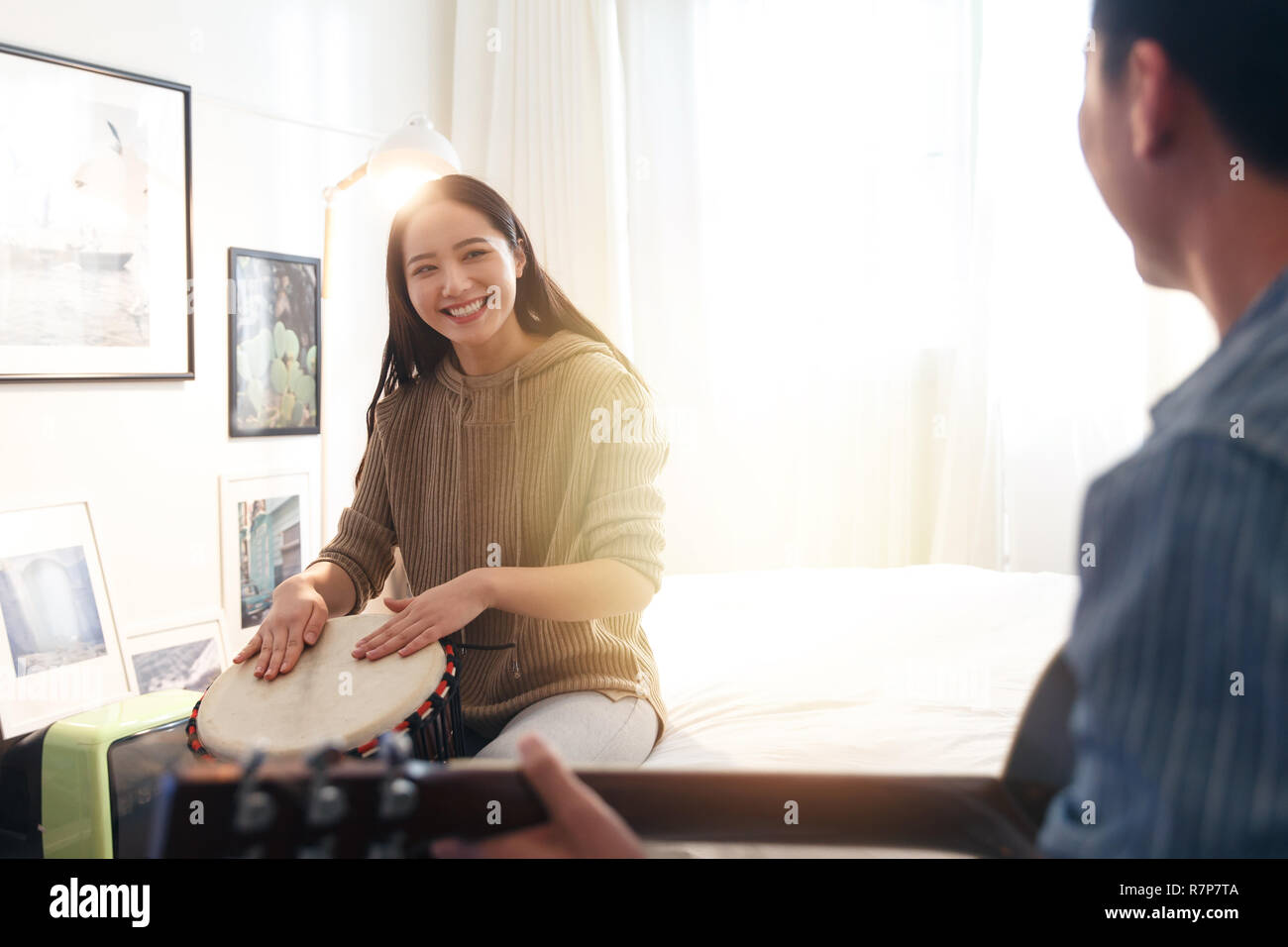 Happy couples playing Musical Instruments at home Stock Photo - Alamy