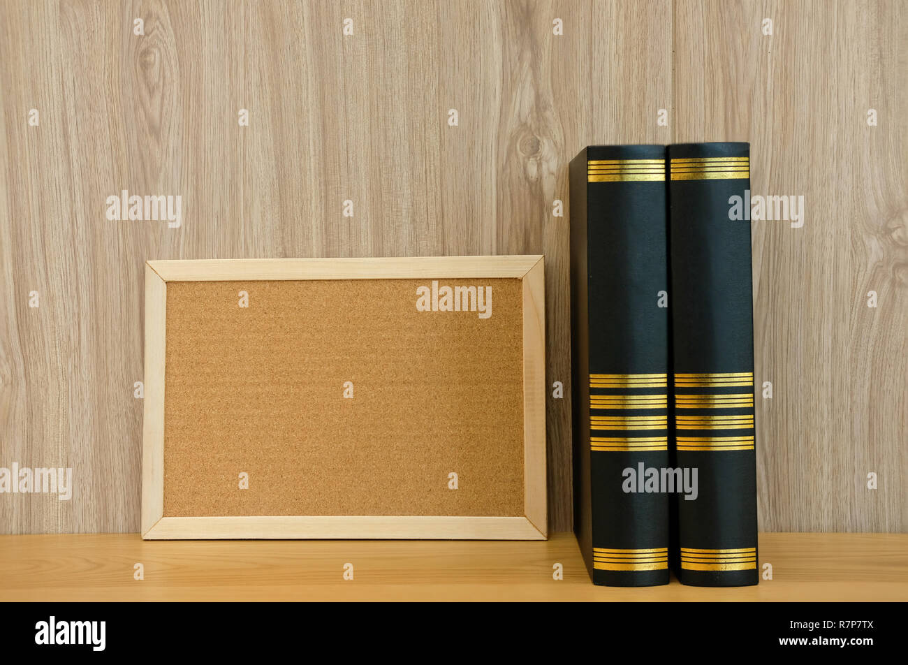 blank cork board & book on wooden desk at workplace. education ...