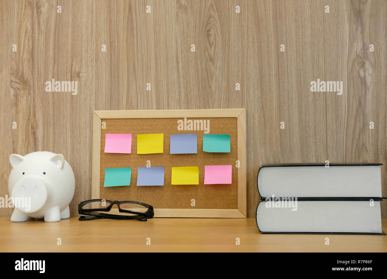 sticky notes paper reminder on cork board & piggy bank. money saving ...
