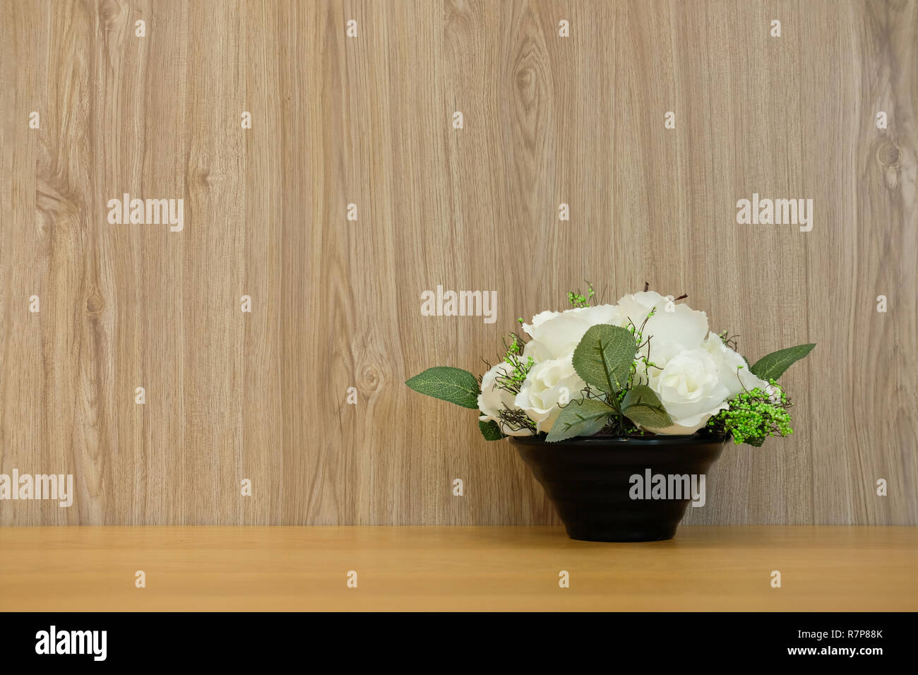 white artificial flower on wooden table at office workplace Stock Photo ...