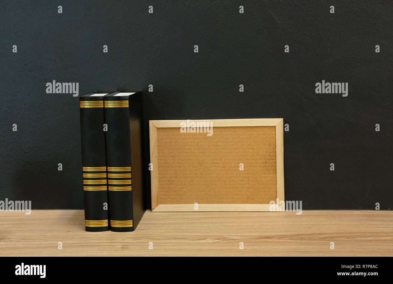 blank cork board & book on wooden desk at workplace. education ...
