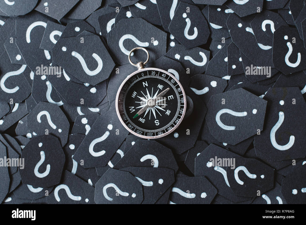 Metal compass on question mark background. Concept of travel ...