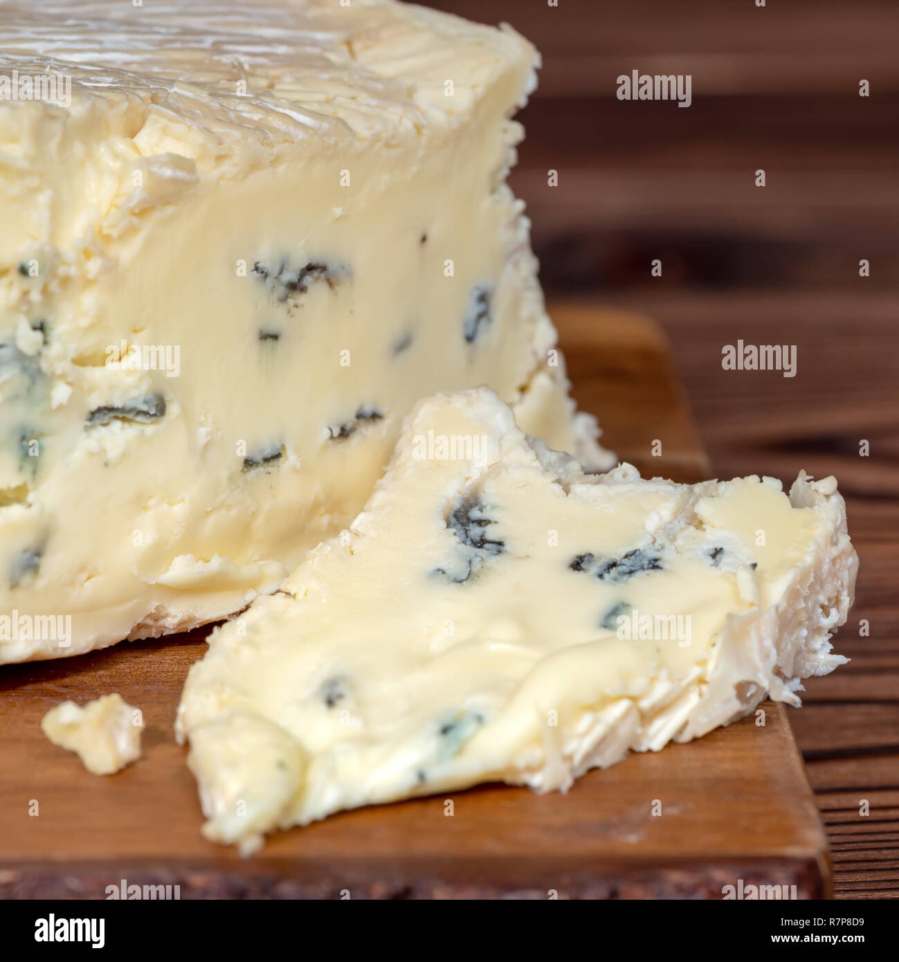 close up texture of blue cheese with mold on wooden background, copy ...