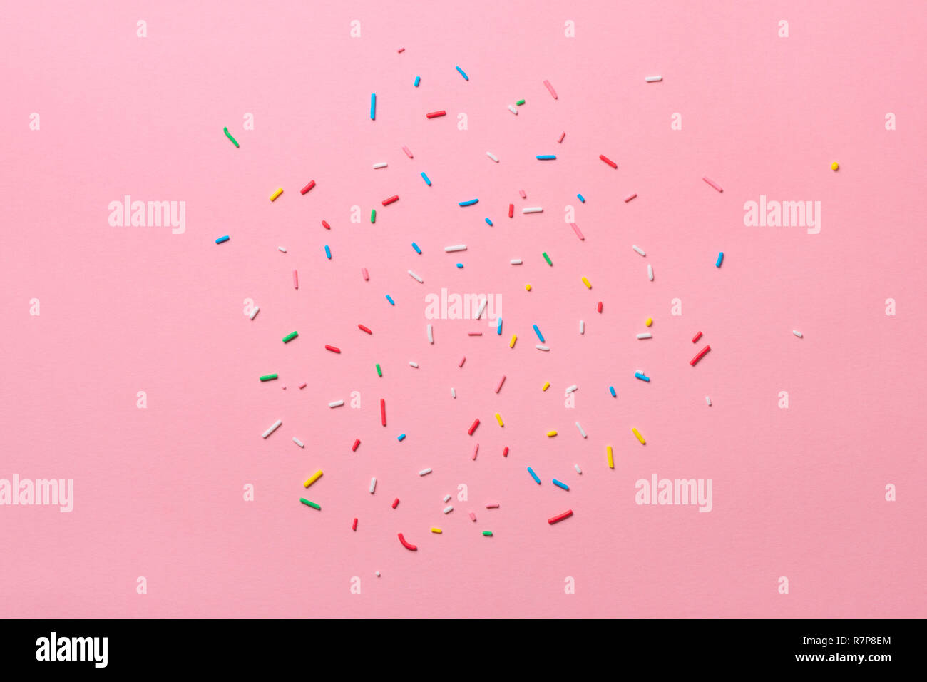 beautiful sugar colorful sprinkles over pink background Stock Photo - Alamy