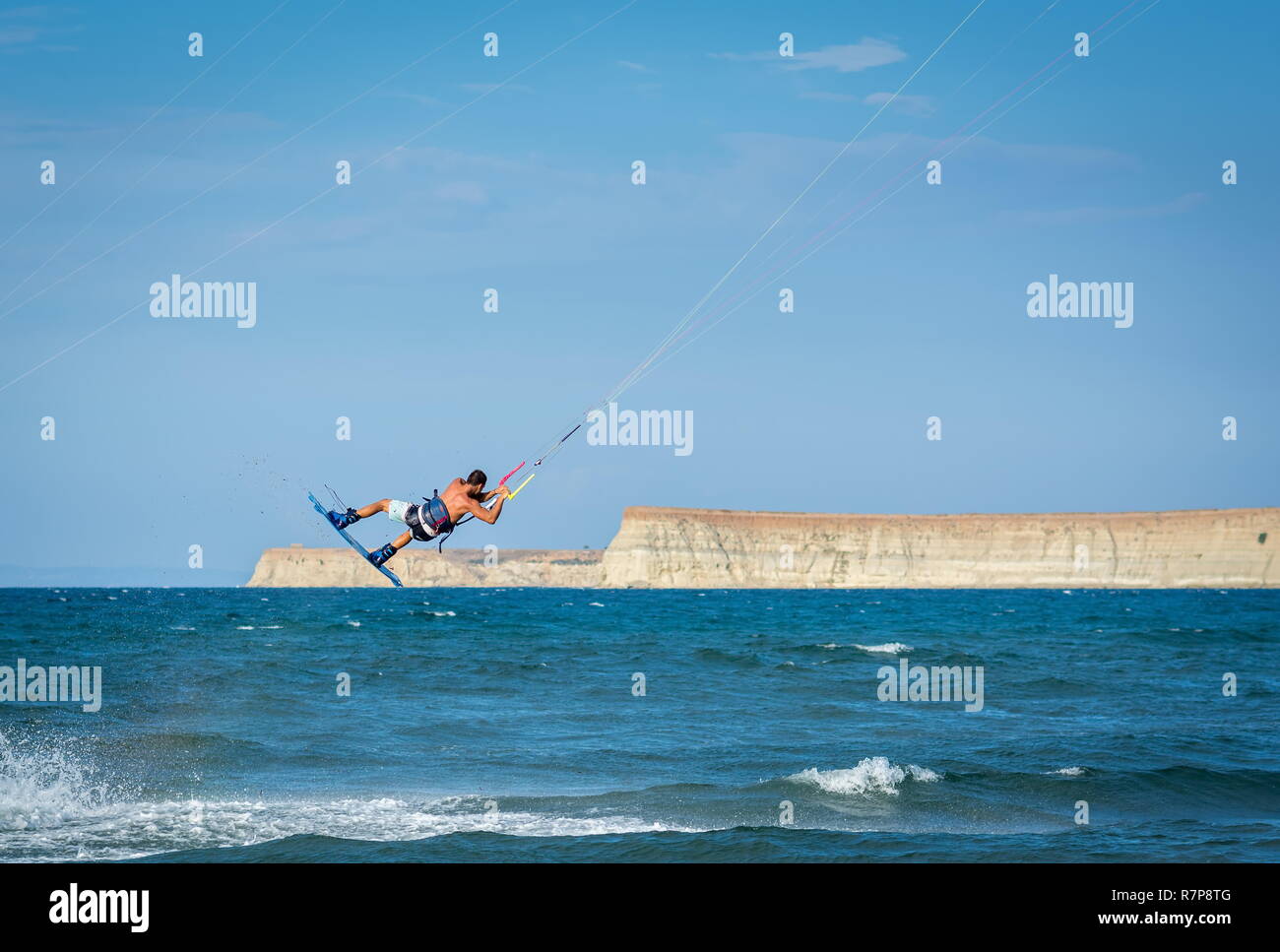 kitesurfer kiteboarder male athlete doing kite tricks and jumps while ...