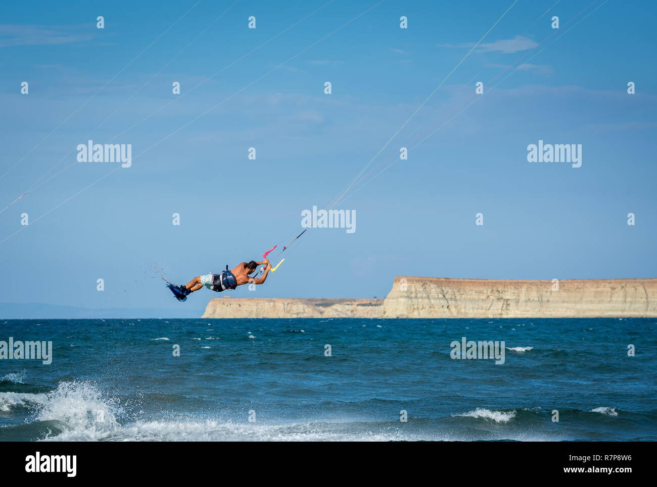 kitesurfer kiteboarder male athlete doing kite tricks and jumps while ...