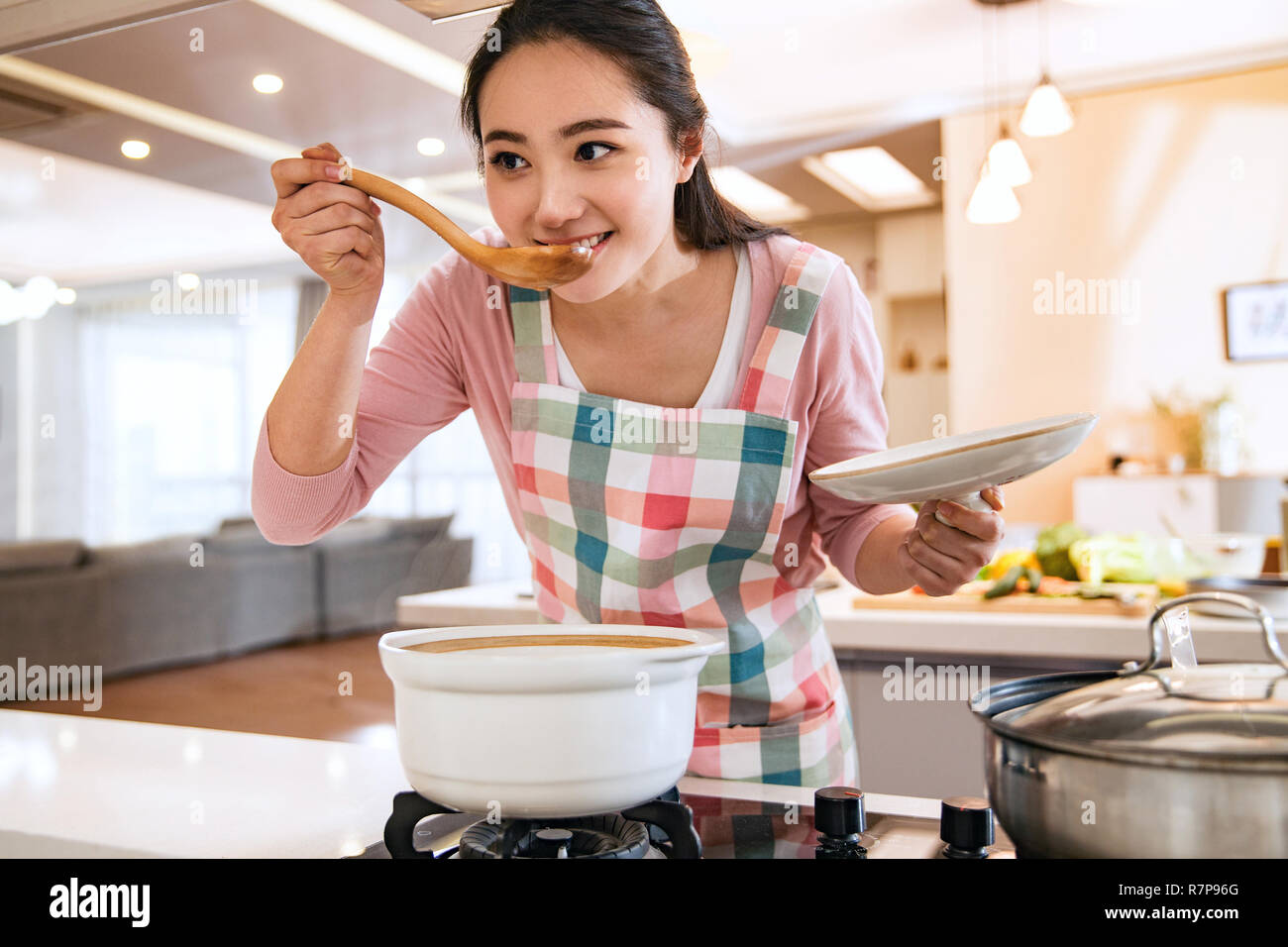 Young woman soup in the kitchen Stock Photo - Alamy