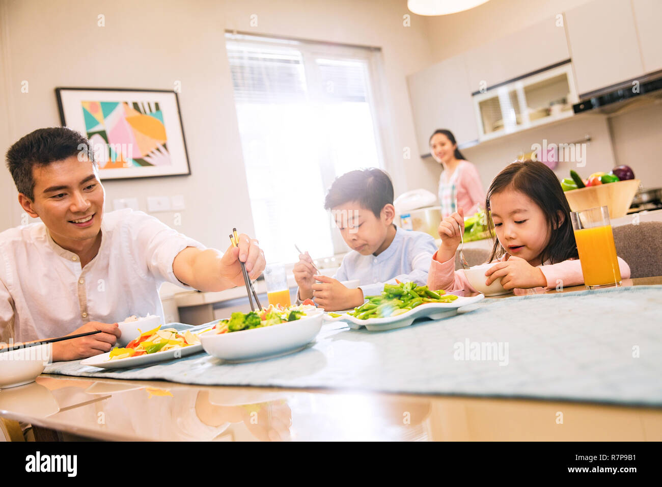 Happy family at dinner Stock Photo - Alamy
