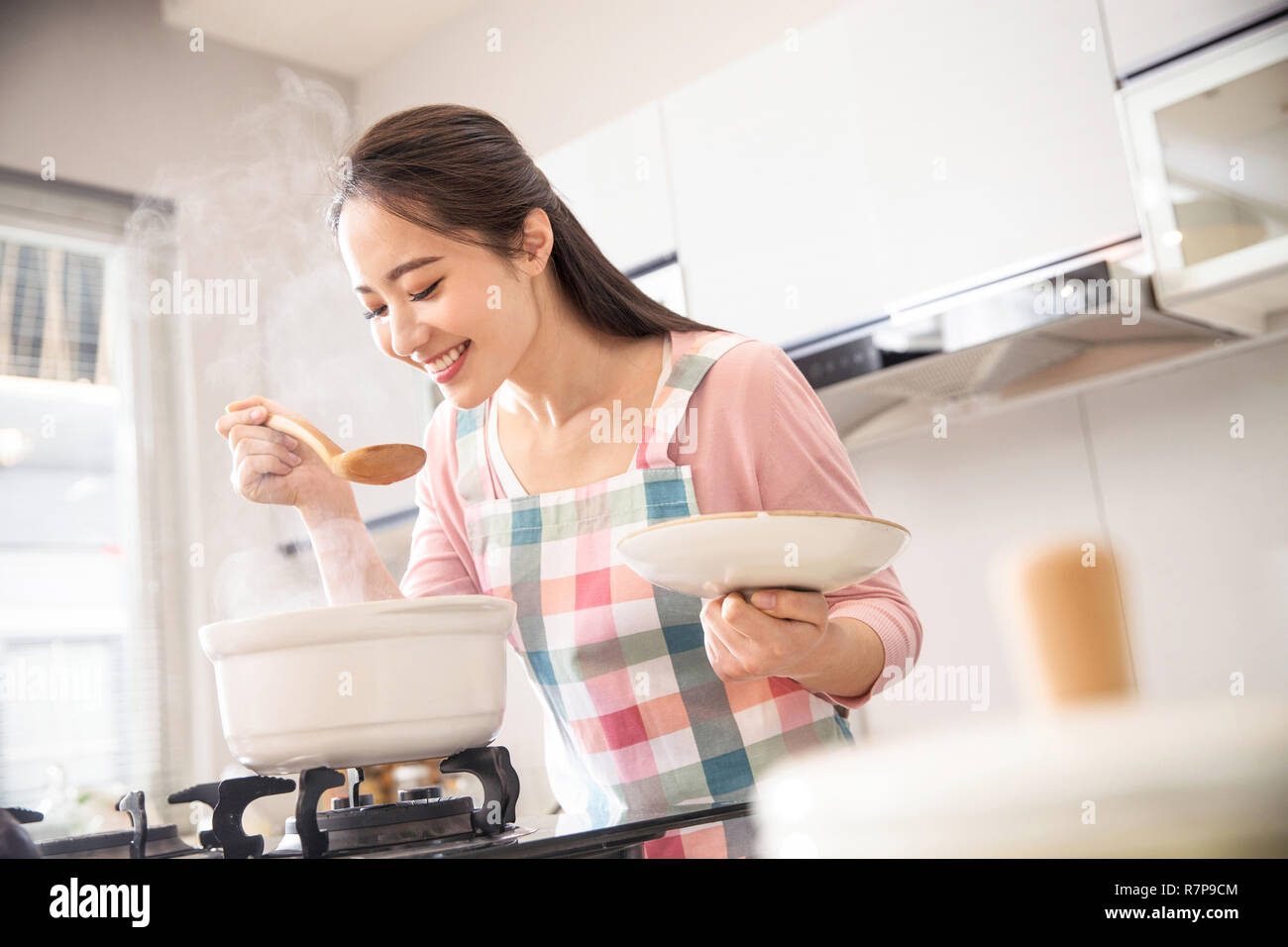 Young woman soup in the kitchen Stock Photo - Alamy