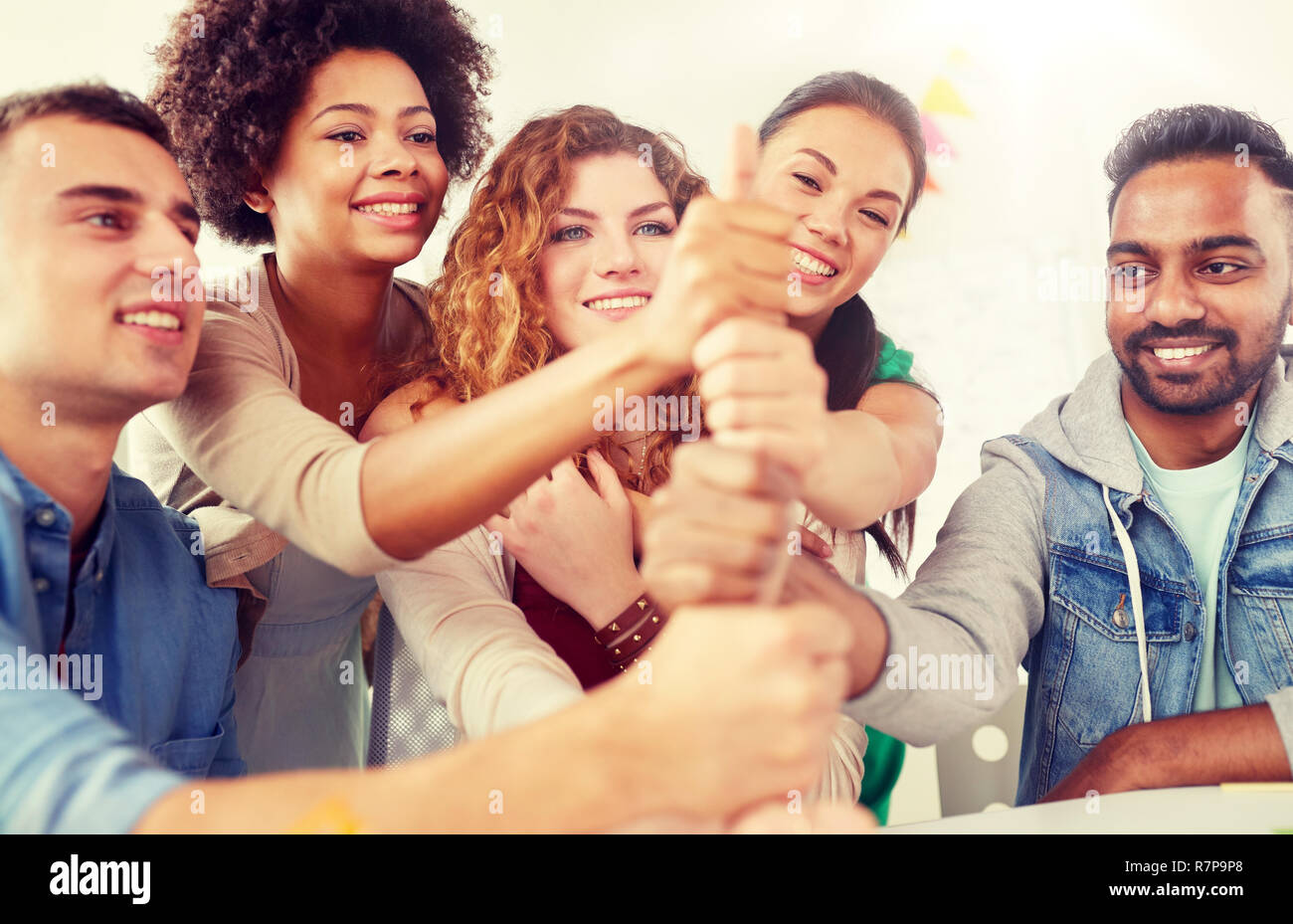 happy office workers doing teamwork gesture Stock Photo - Alamy