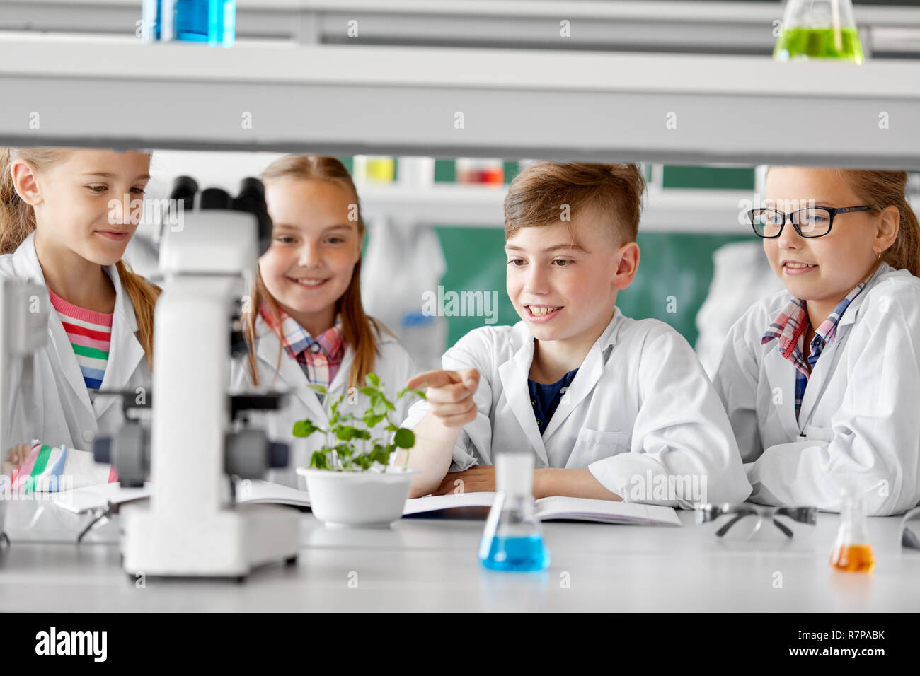 kids or students with plant at biology class Stock Photo - Alamy