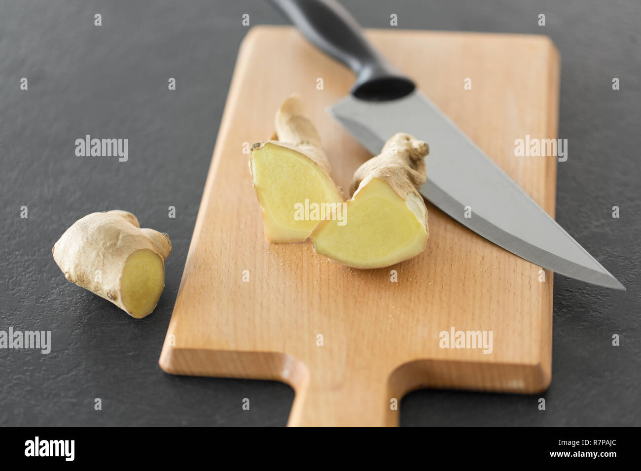 close up of ginger root and knife on cutting board Stock Photo - Alamy