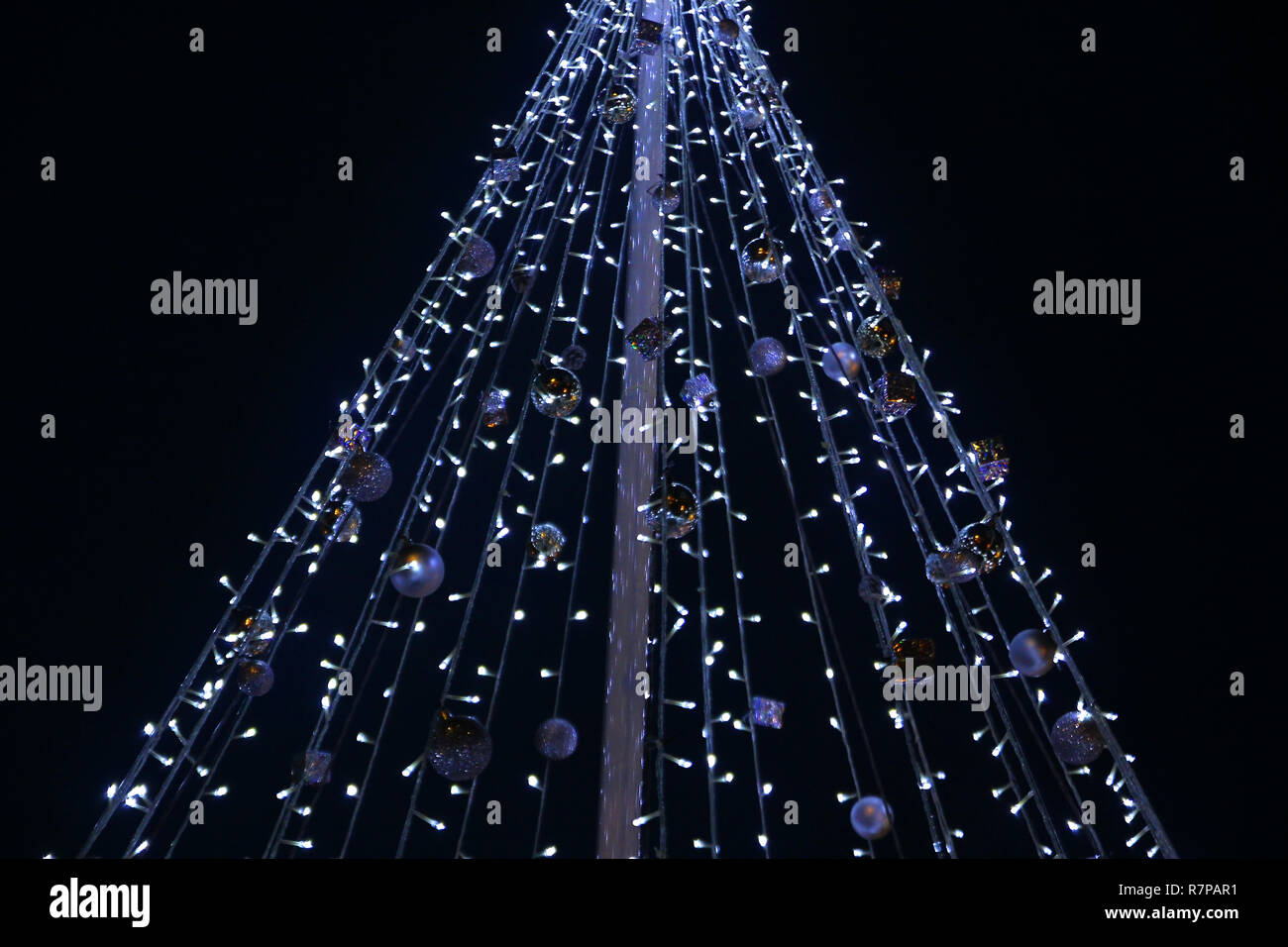 christmas tree decorated by lights at night Stock Photo - Alamy