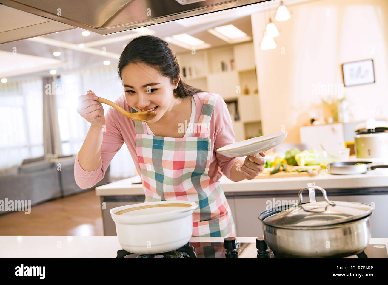 Young woman soup in the kitchen Stock Photo - Alamy