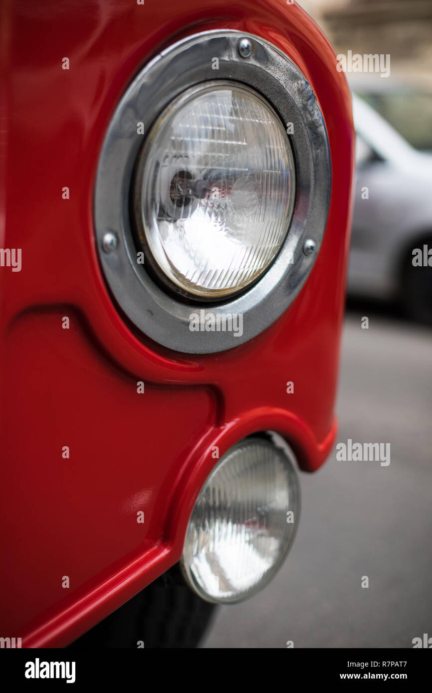 Detail of a red double decker bus headlight Stock Photo - Alamy