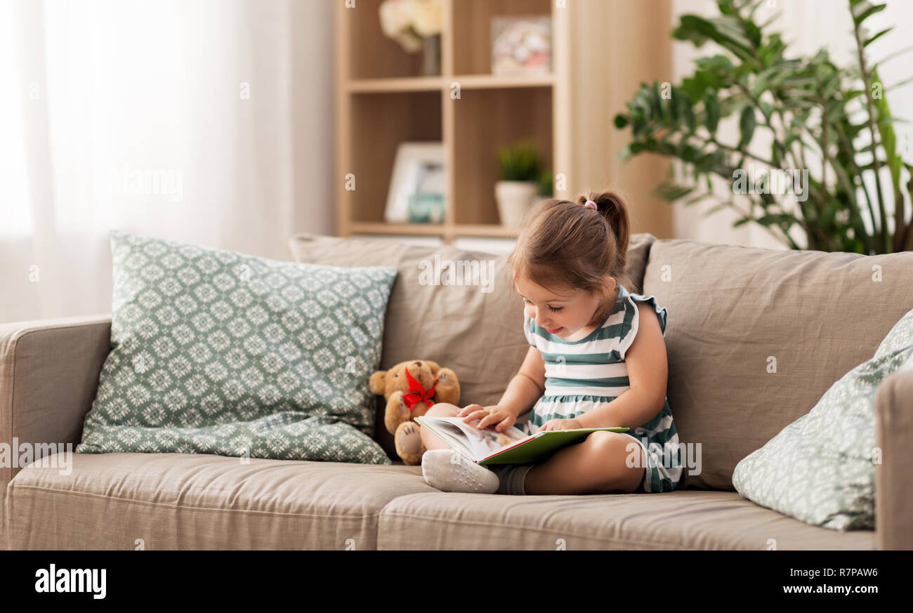 little girl reading book at home Stock Photo - Alamy
