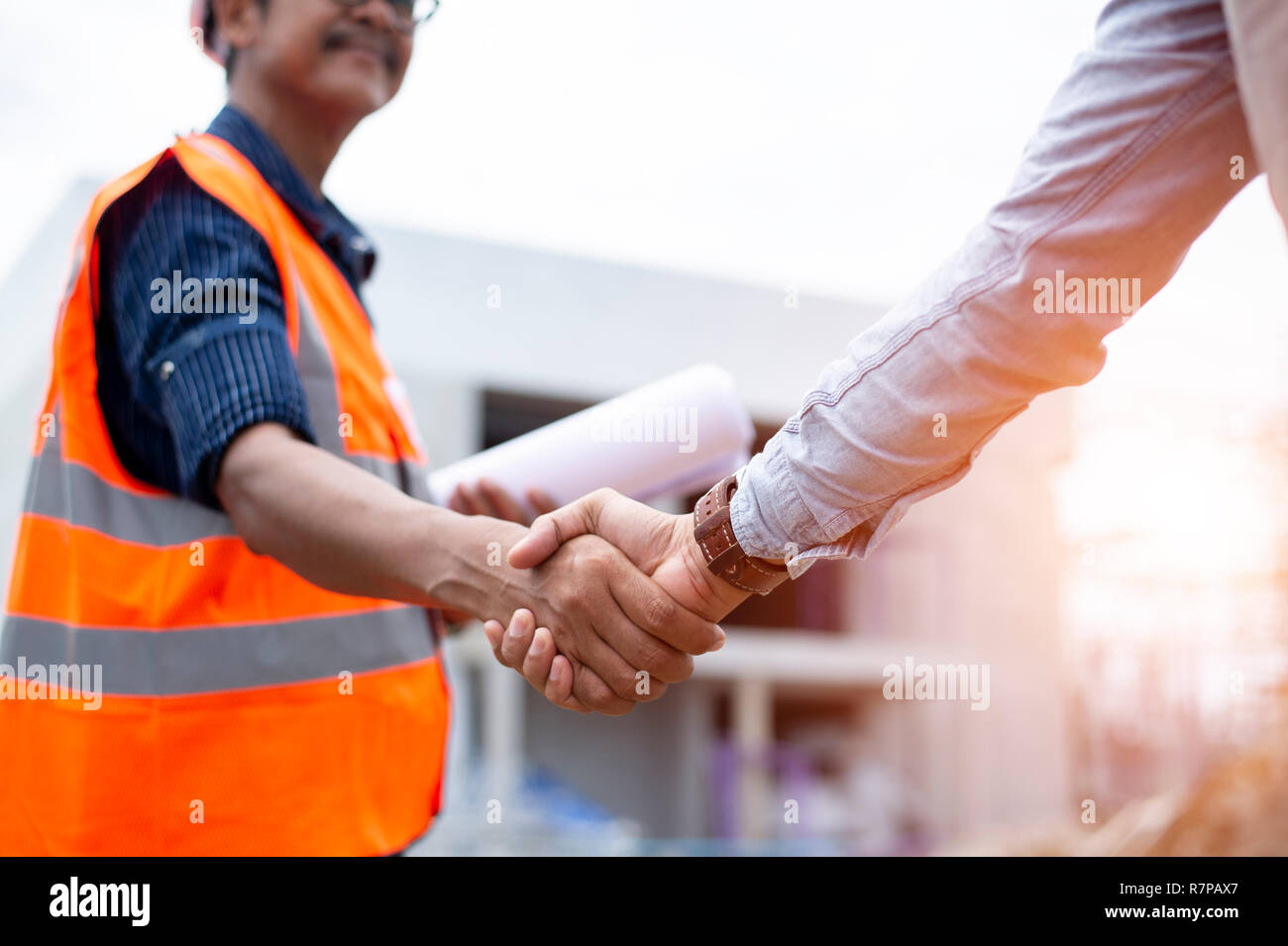 Engineer man handshake with asian business after finishing up meeting ...