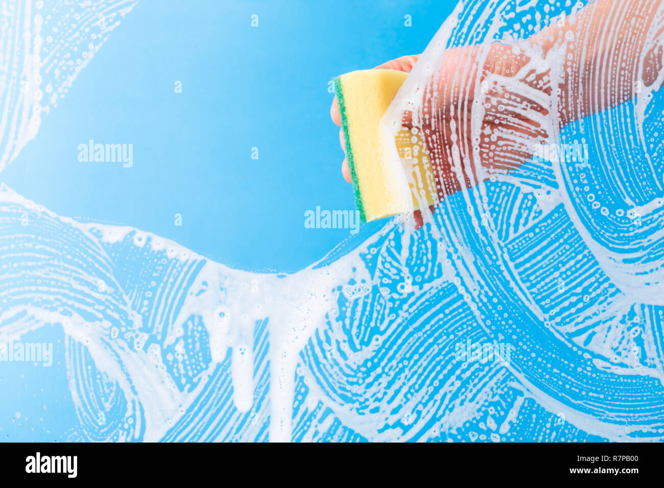 Hand cleaning glass window pane with detergent by sponge Stock Photo ...