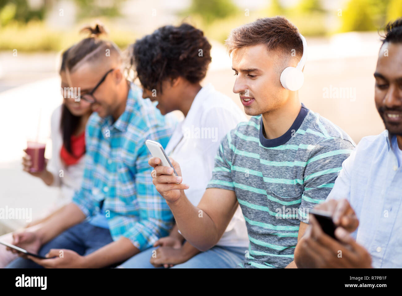 man with friends listening to music on smartphone Stock Photo - Alamy