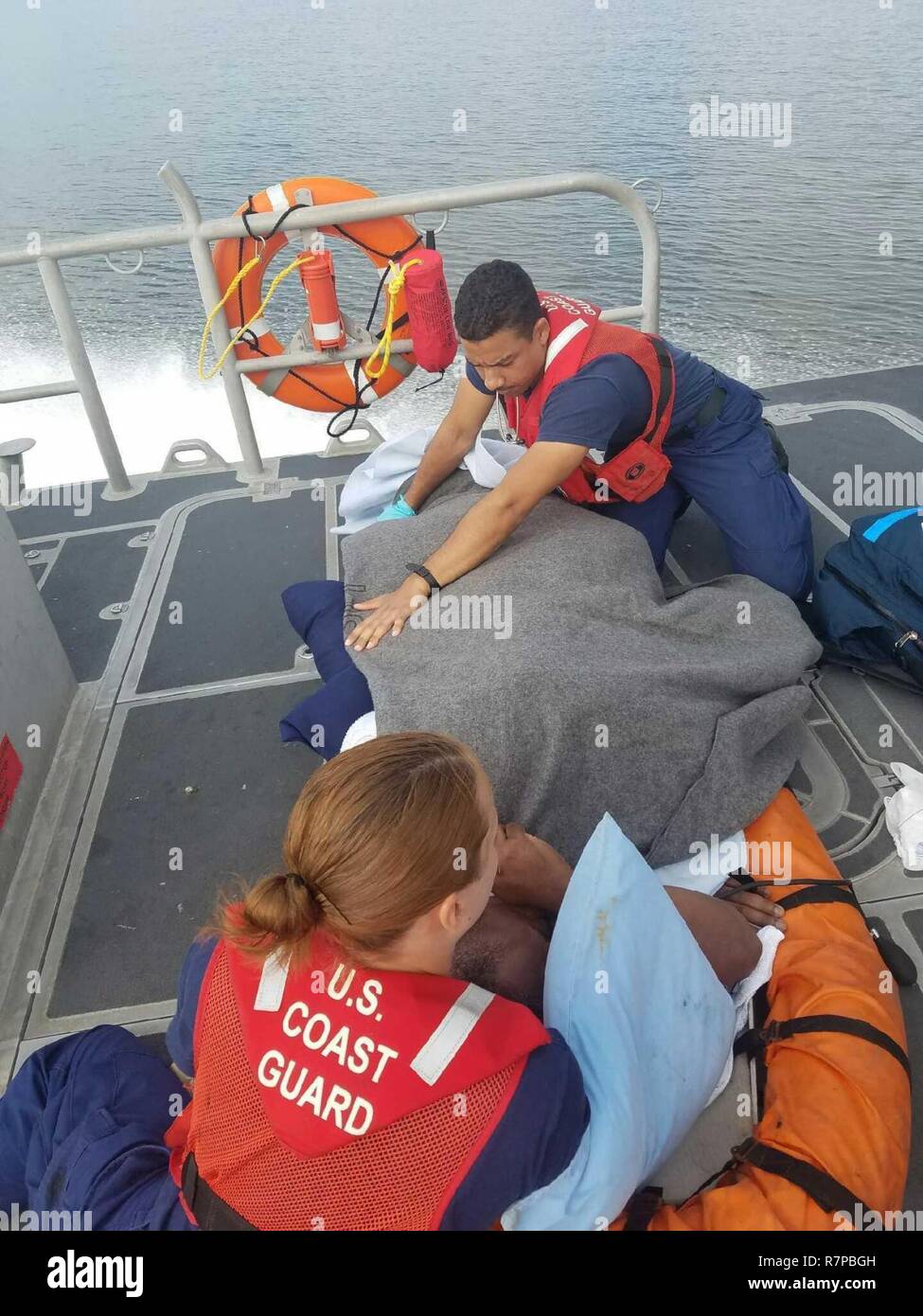 Seaman Martin Sissac and Petty Officer 3rd class Kaylee Harding tend to ...