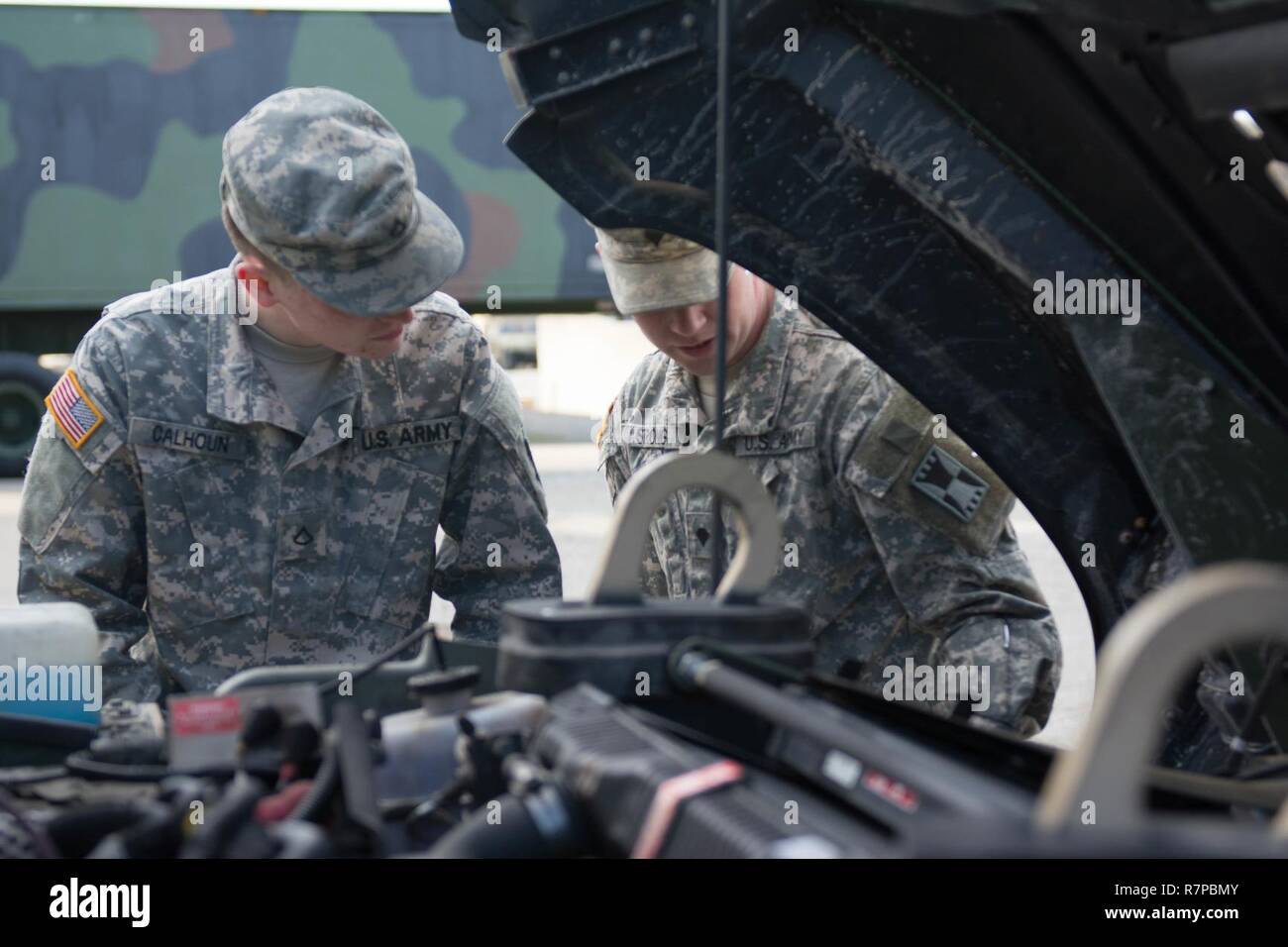 PFC Rick Calhoun, left, a supply specialist, is instructed by SPC Kyle ...
