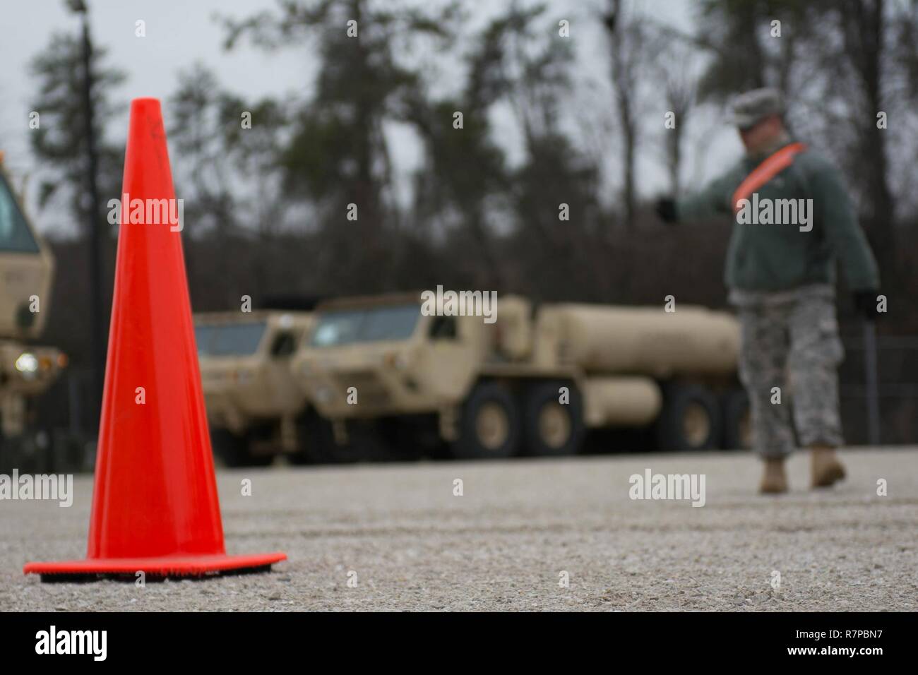 A Soldier with HHC 416th TEC ground guides an M1083 medium tactical ...