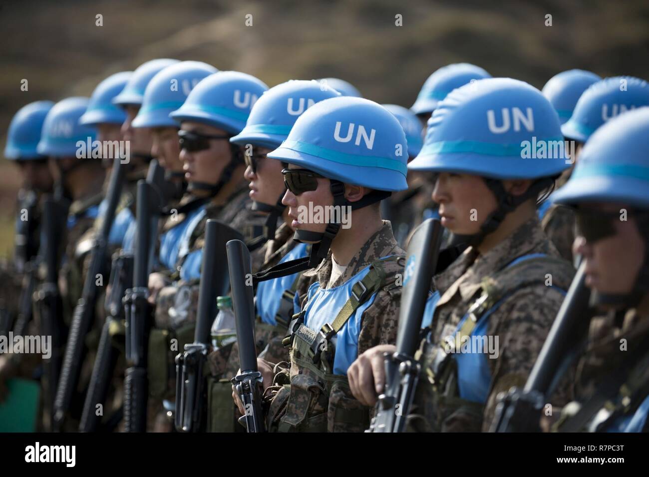 A platoon of Mongolian soldiers stand in formation as they receive a ...