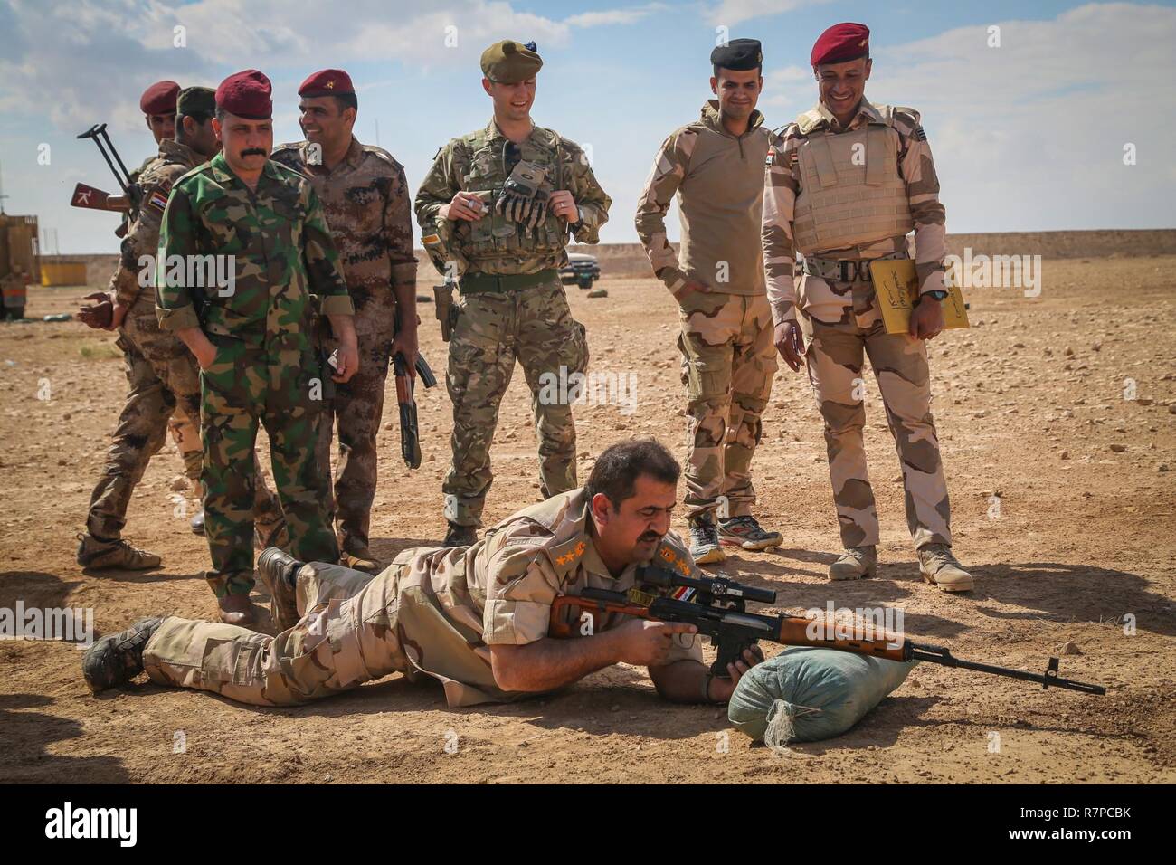An Iraqi security forces colonel prepares to fire his Dragunov rifle ...