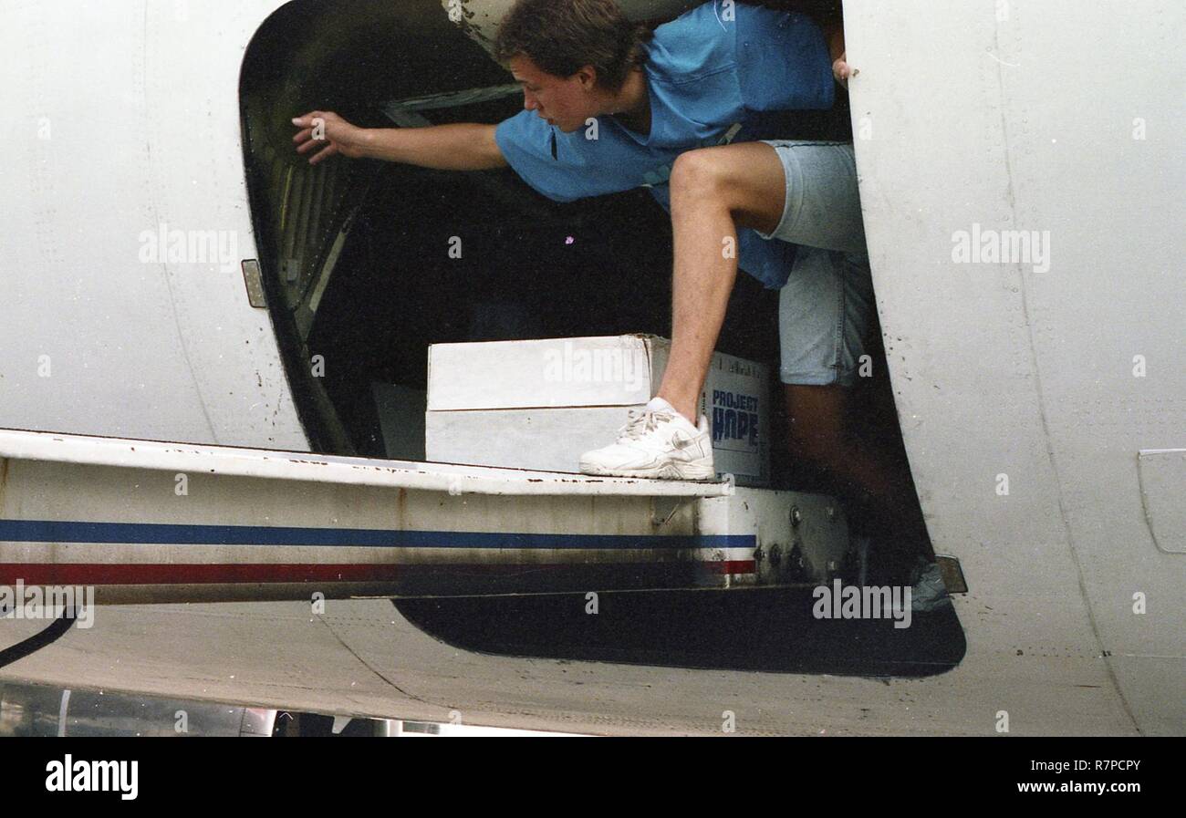 MAN INSIDE AIRPLANE; REACHING FOR HATCH DOOR Stock Photo - Alamy