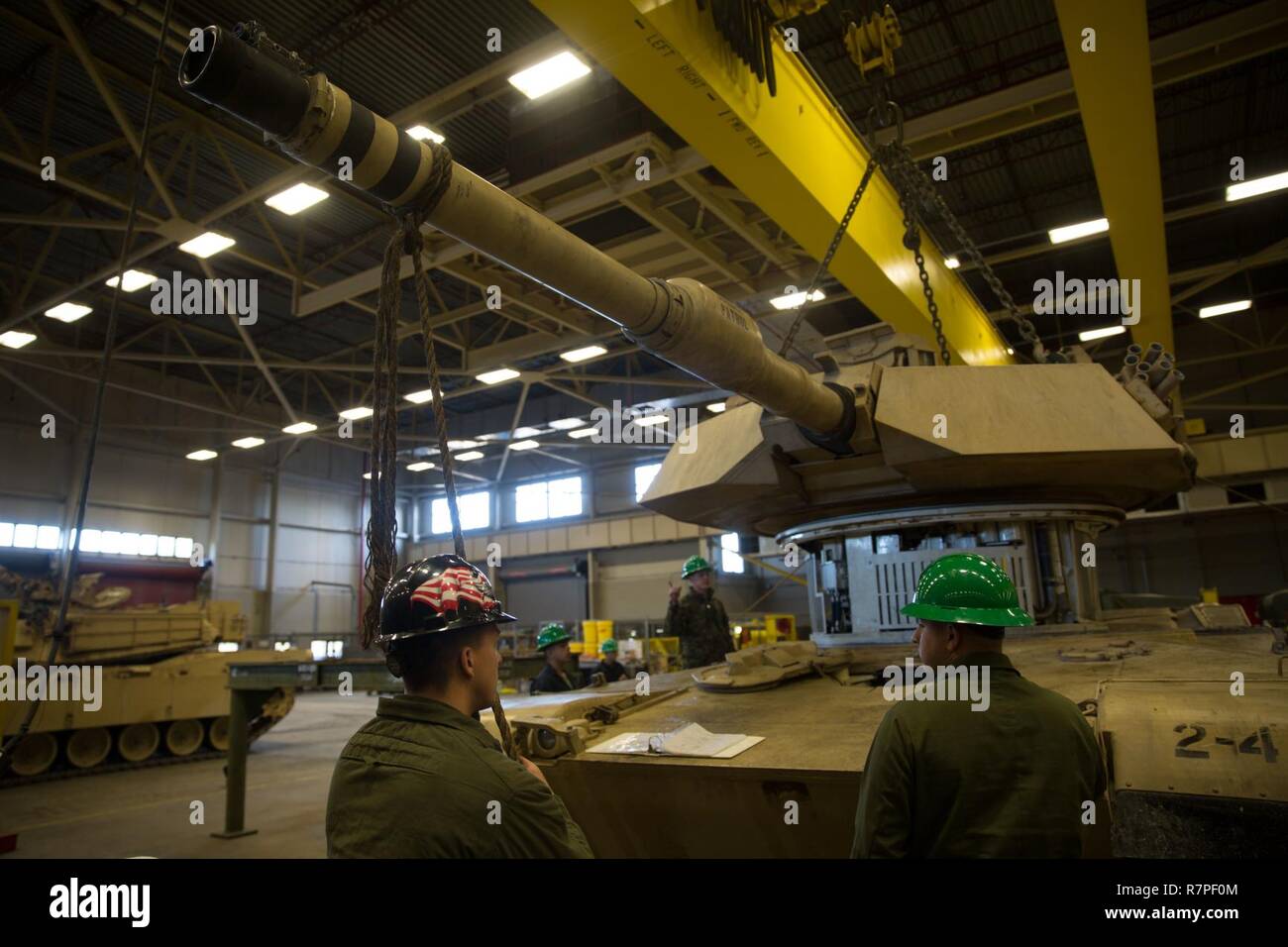 Marines hold ropes to steady an M1A1 Abrams tank’s 120mm turret before ...
