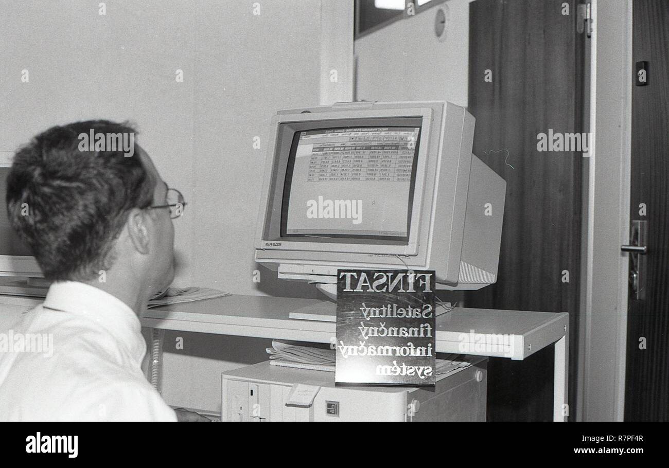 A MAN SITTING AT HIS DESK LOOKING AT HIS COMPUTER Stock Photo - Alamy