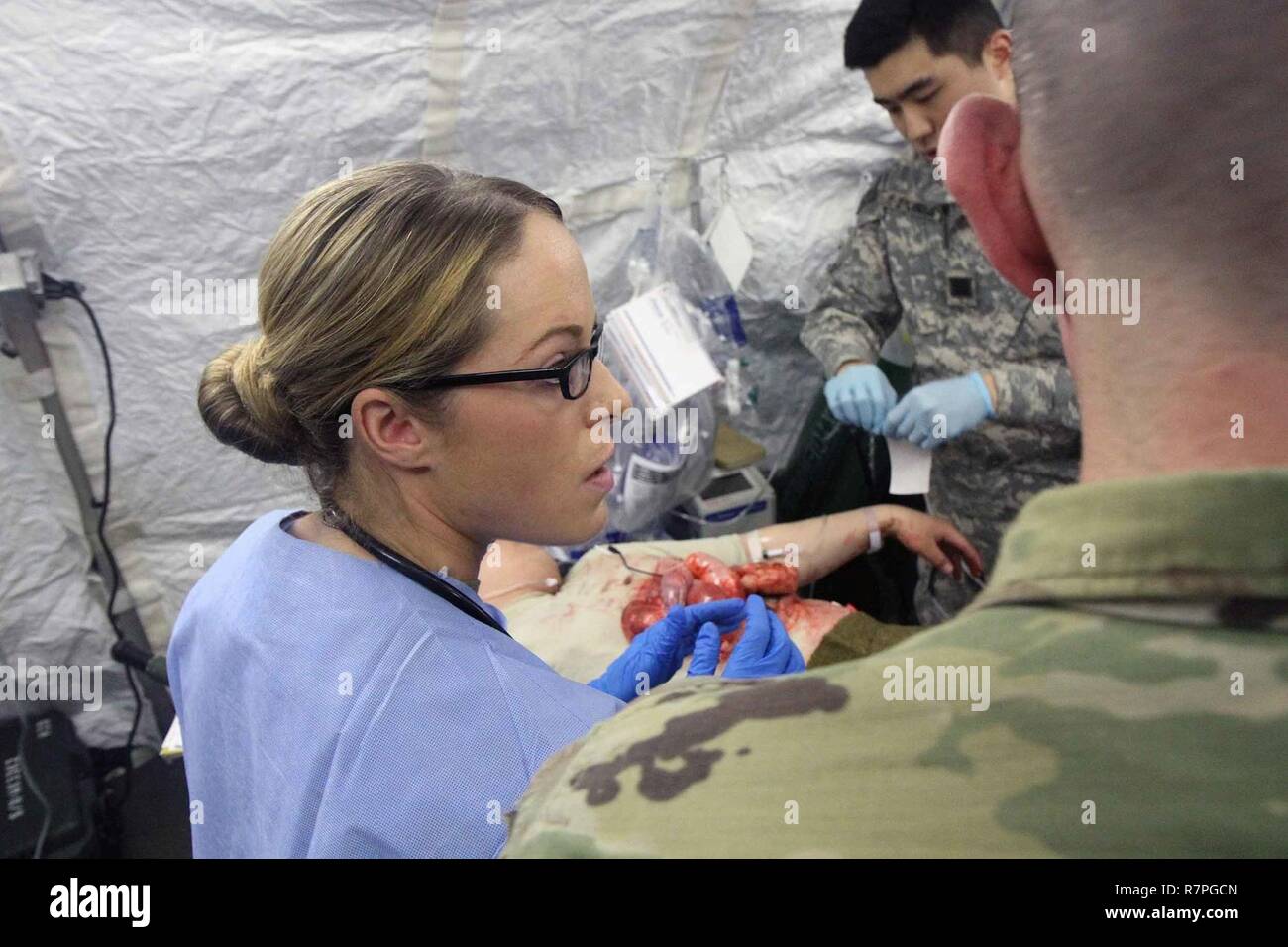 Medical personnel with the 121st Combat Support Hospital assess a ...