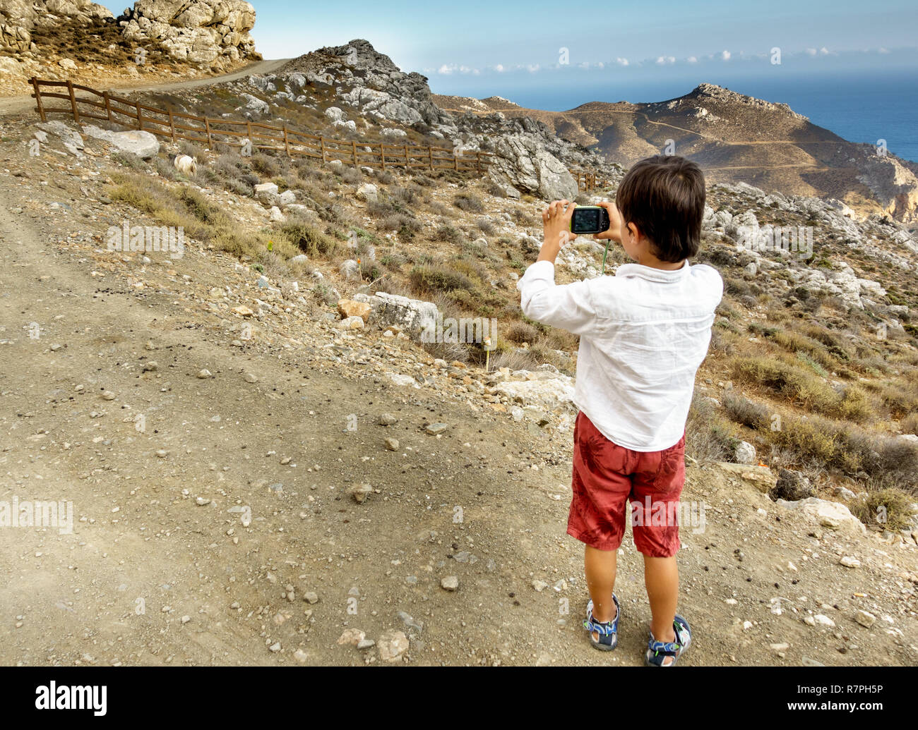 Boy photographing landscape Stock Photo - Alamy