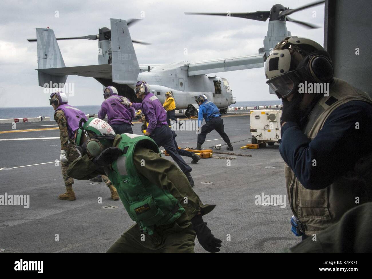EAST CHINA SEA (March 24, 2017) Sailors and Marines brace against the ...