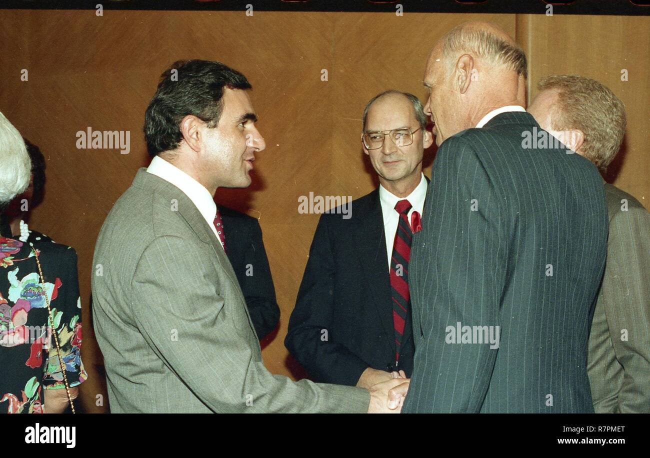 A GROUP OF MEN ARE GREETING EACH OTHER AND HAVING A CONVERSATION Stock ...
