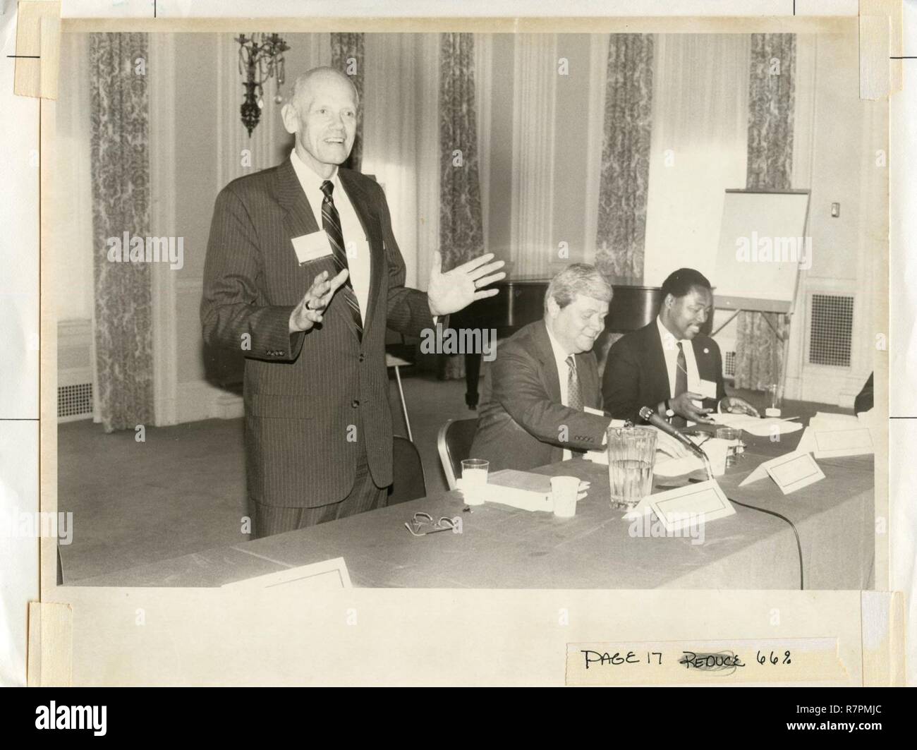 THREE MEN AT THE TABLE WHICH ONE OF THEM IS TALKING Stock Photo - Alamy
