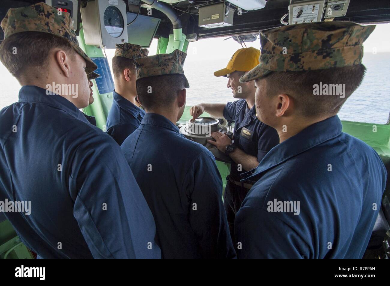 PHILIPPINE SEA (March 28, 2017) Ensign Bryce Lowry, center, from ...