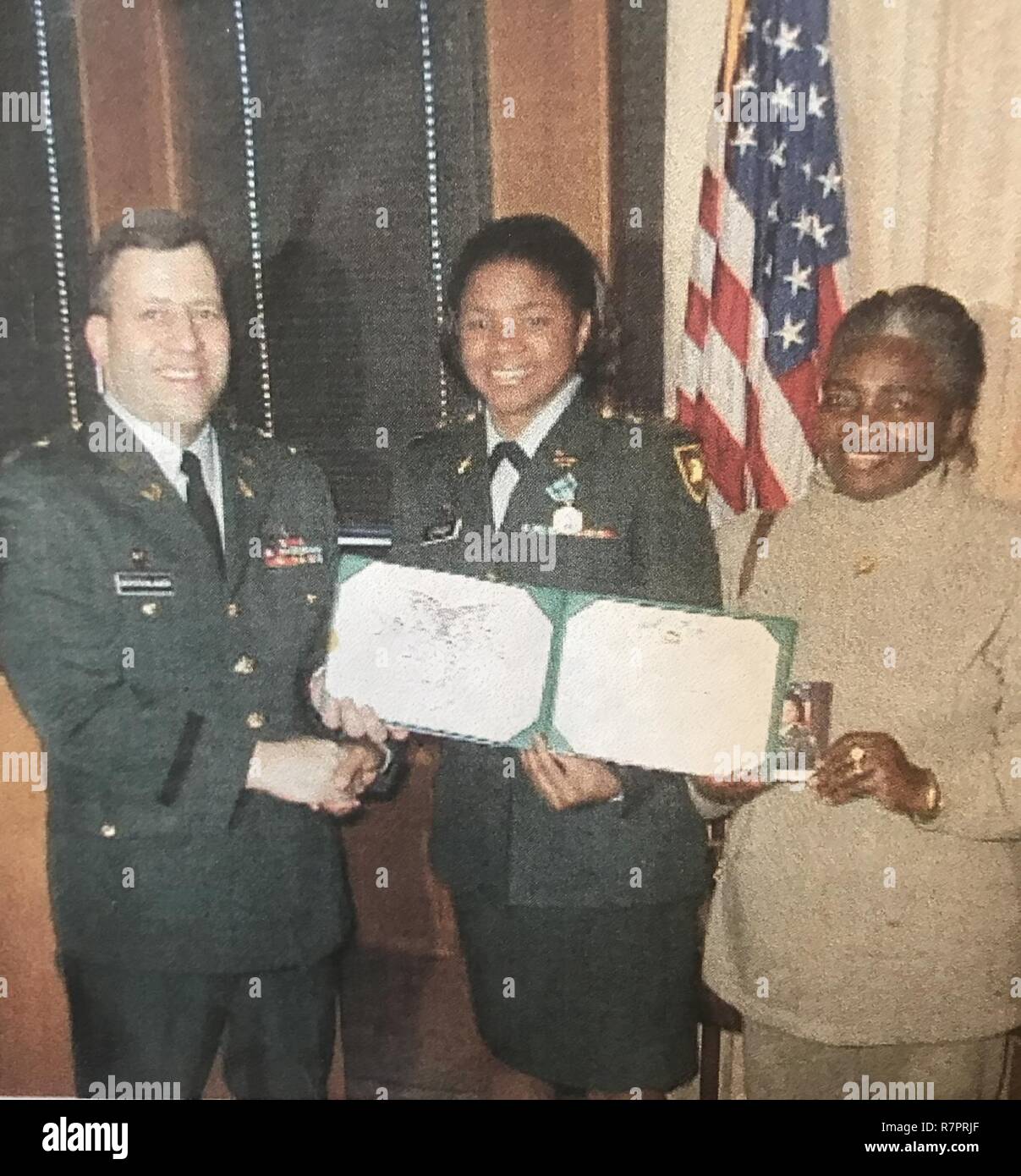 U.S. Army Lt. Col. James Gerstenlauer presents Capt. Claudia Lynch and ...
