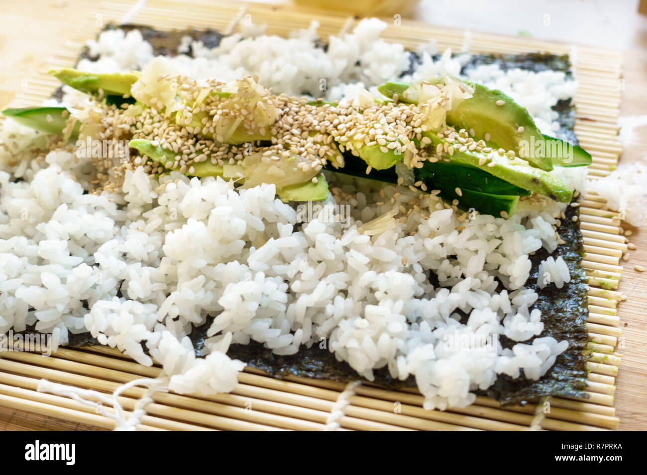 Sushi rice on nori sheet Stock Photo - Alamy