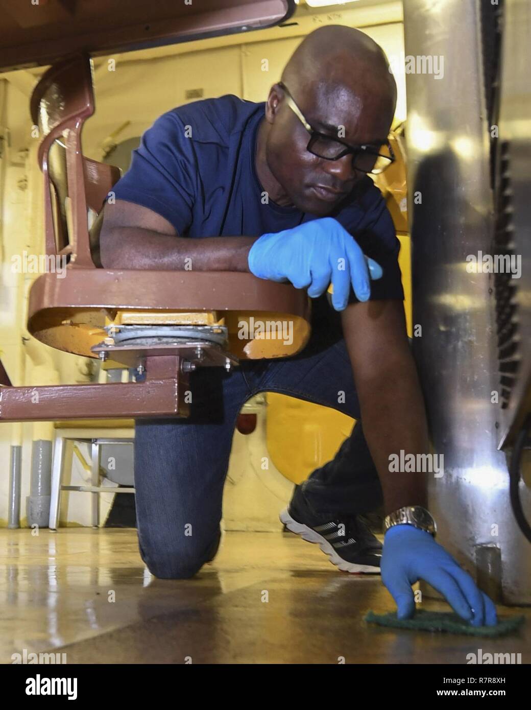 NORFOLK, VA (March 29, 2017) Chief Electrician’s Mate Rotimi Oke scrubs ...