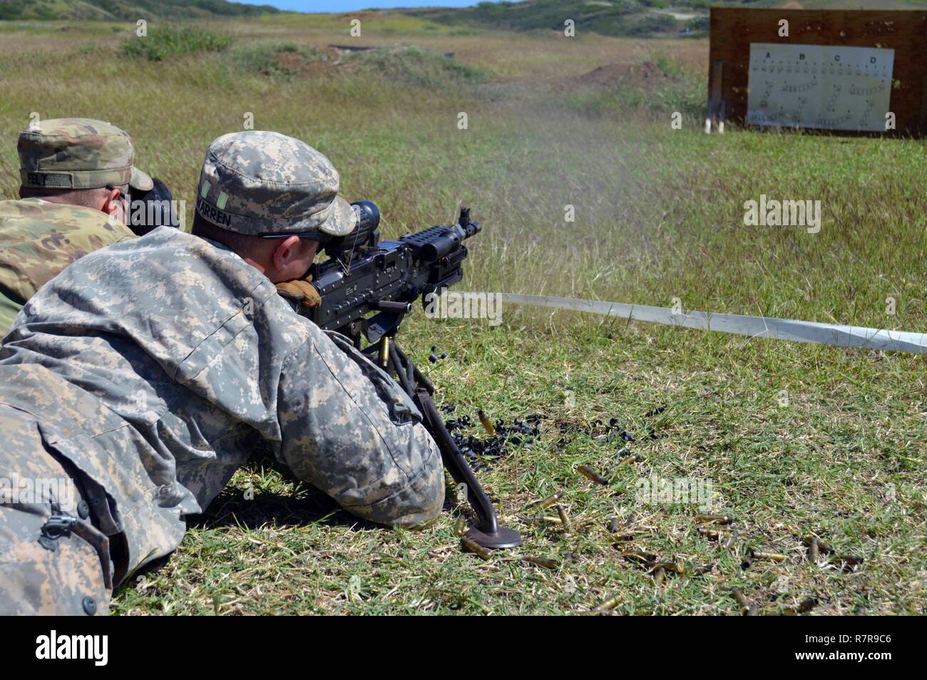 Pfc. William Warren fires an M240 machine gun while his assistant ...