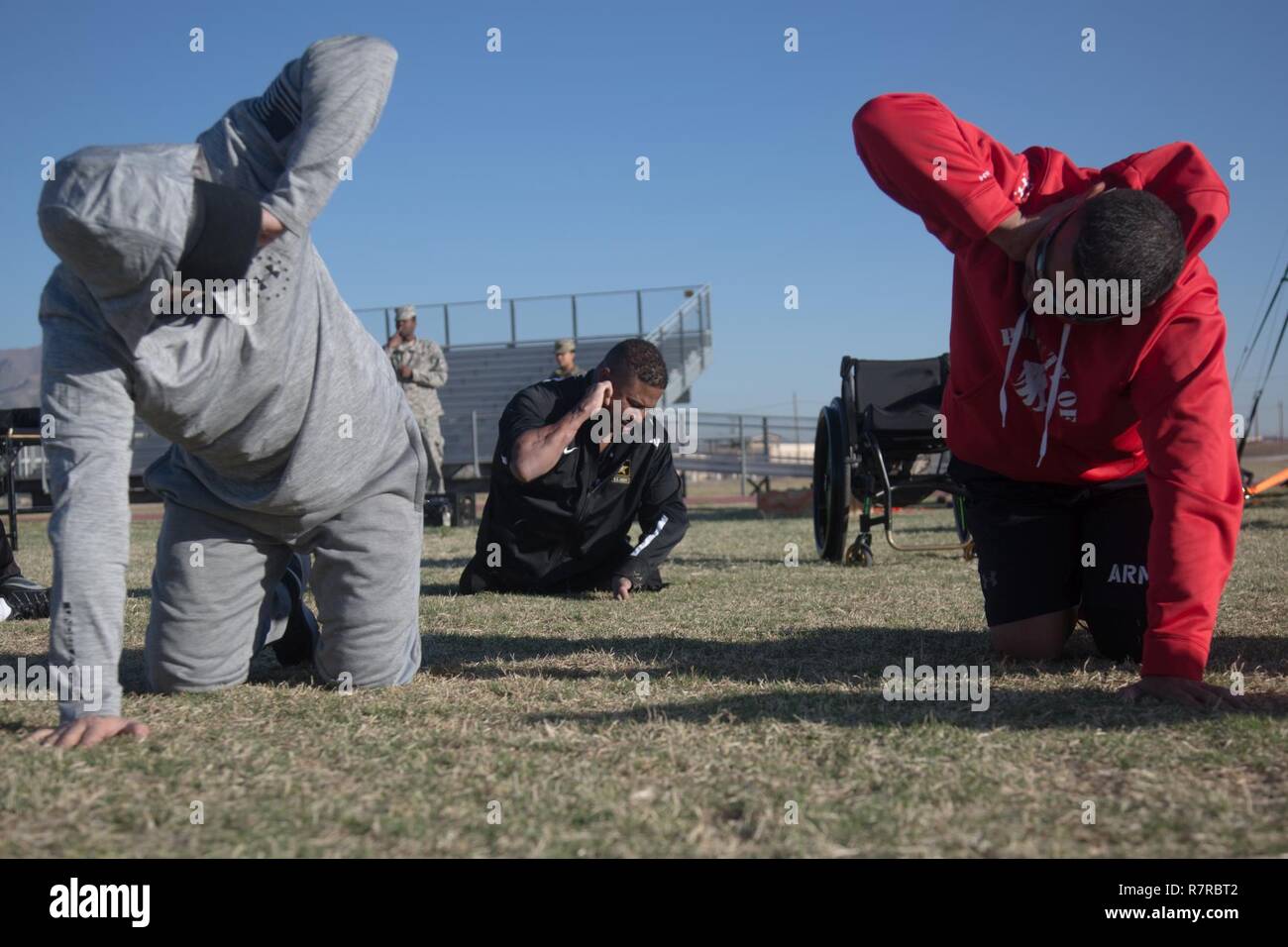 U.S. Army Soldiers and veterans stretch before practicing for the event ...