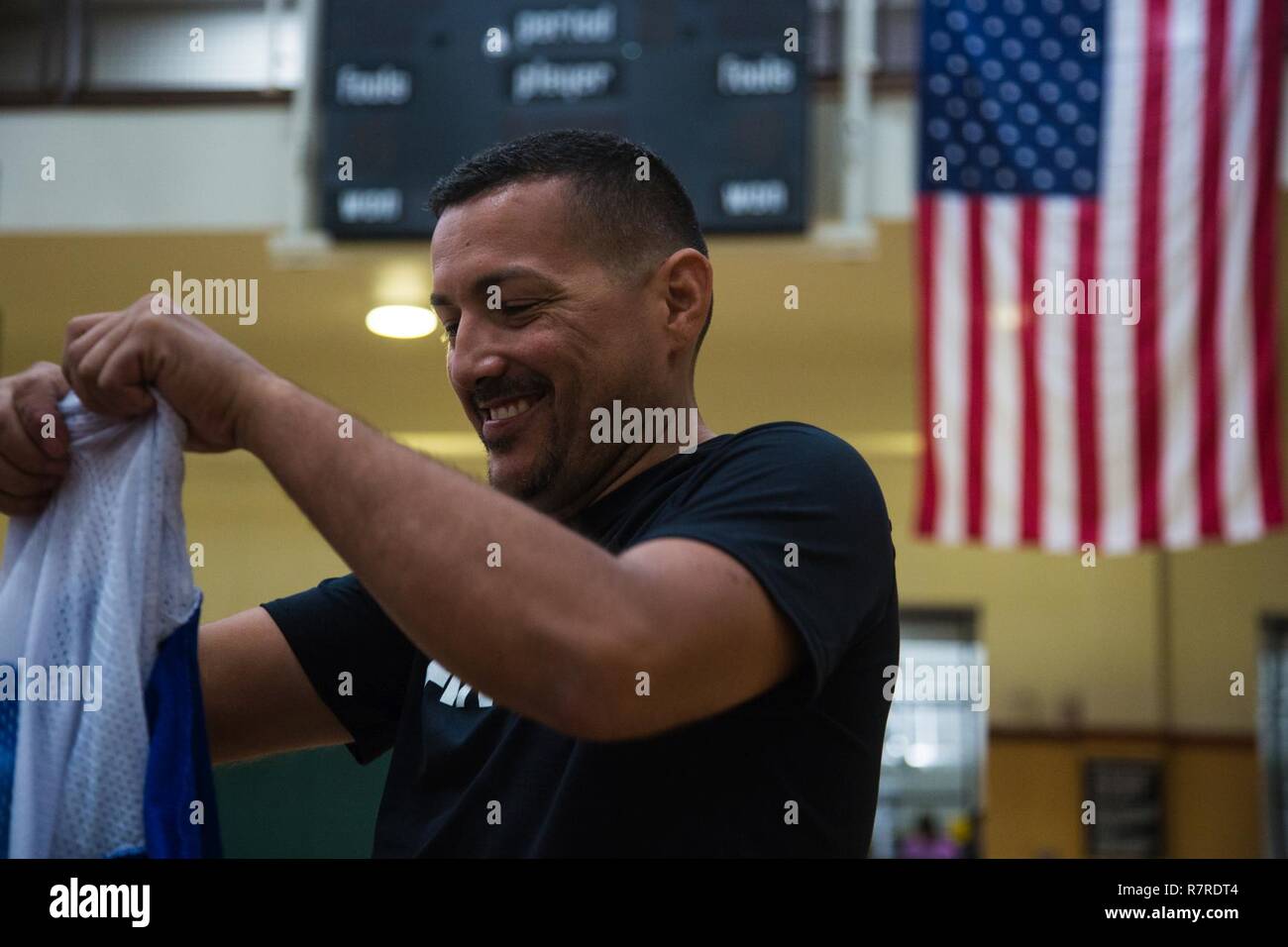 U.S. Army veteran, Aristoles Colon, smiles as he puts on his jersey for ...