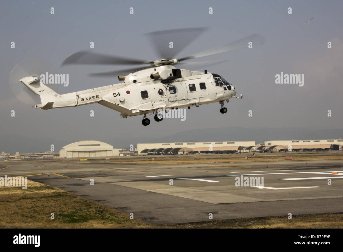 A Japanese MCH-101 airborne mine countermeasures helicopter lands on a heliport designated by ...