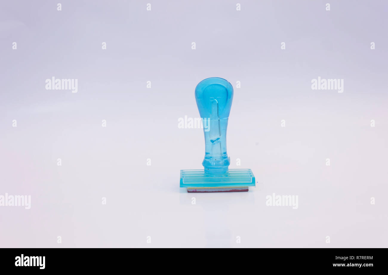 Rubber stamp with blue ink on isolated white background in space office ...